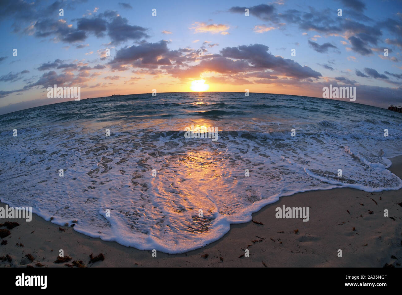 Fisheye view of sunrise over waves on Miami Beach, Florida Stock Photo ...