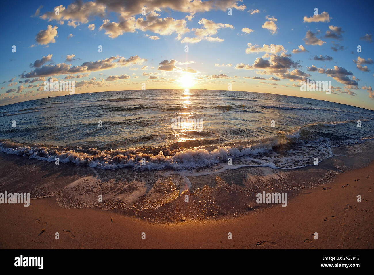 Fisheye view of sunrise over waves on Miami Beach, Florida Stock Photo ...