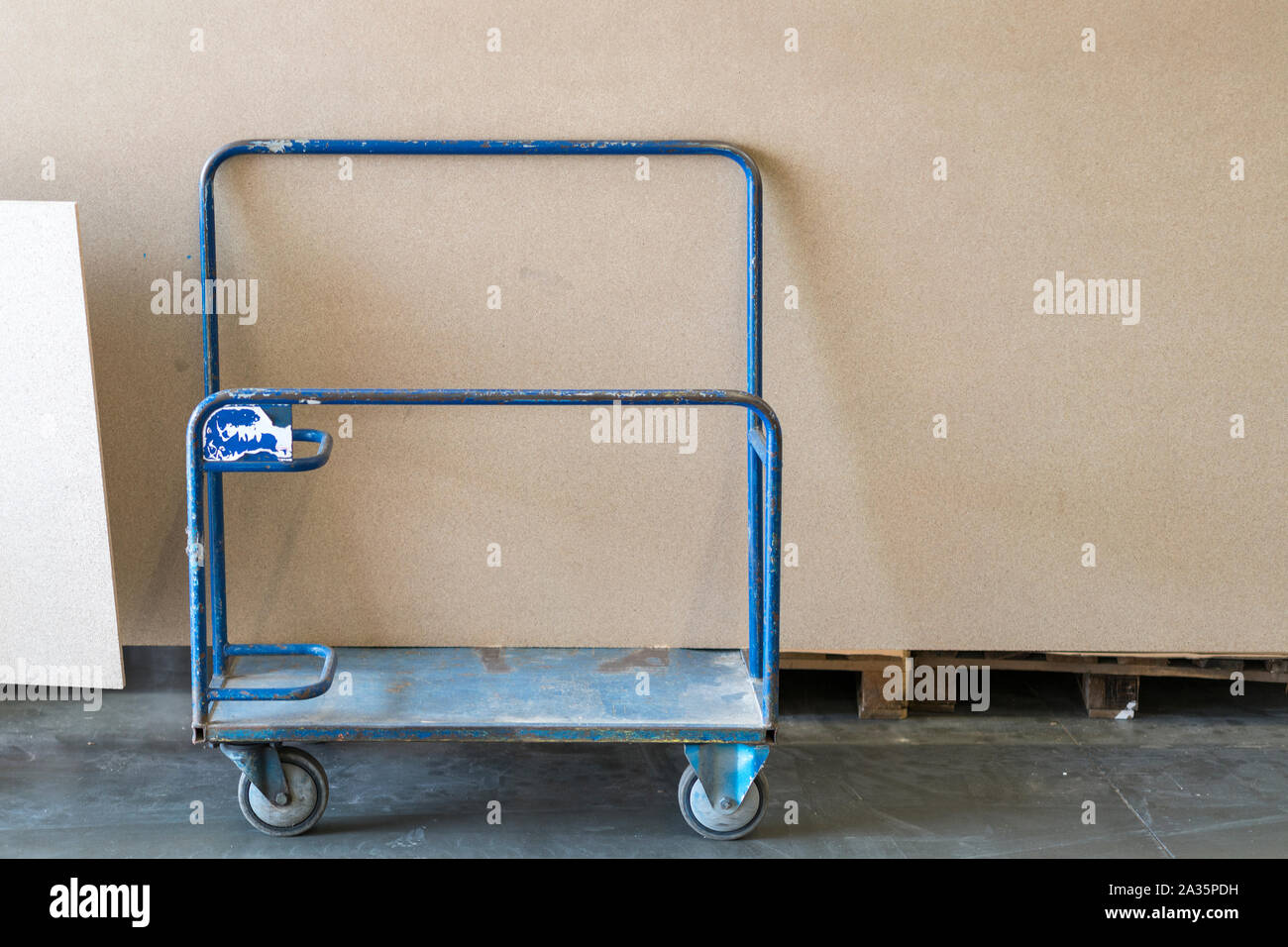 Trolley in a hardware store with building materials. Warehouse large ...