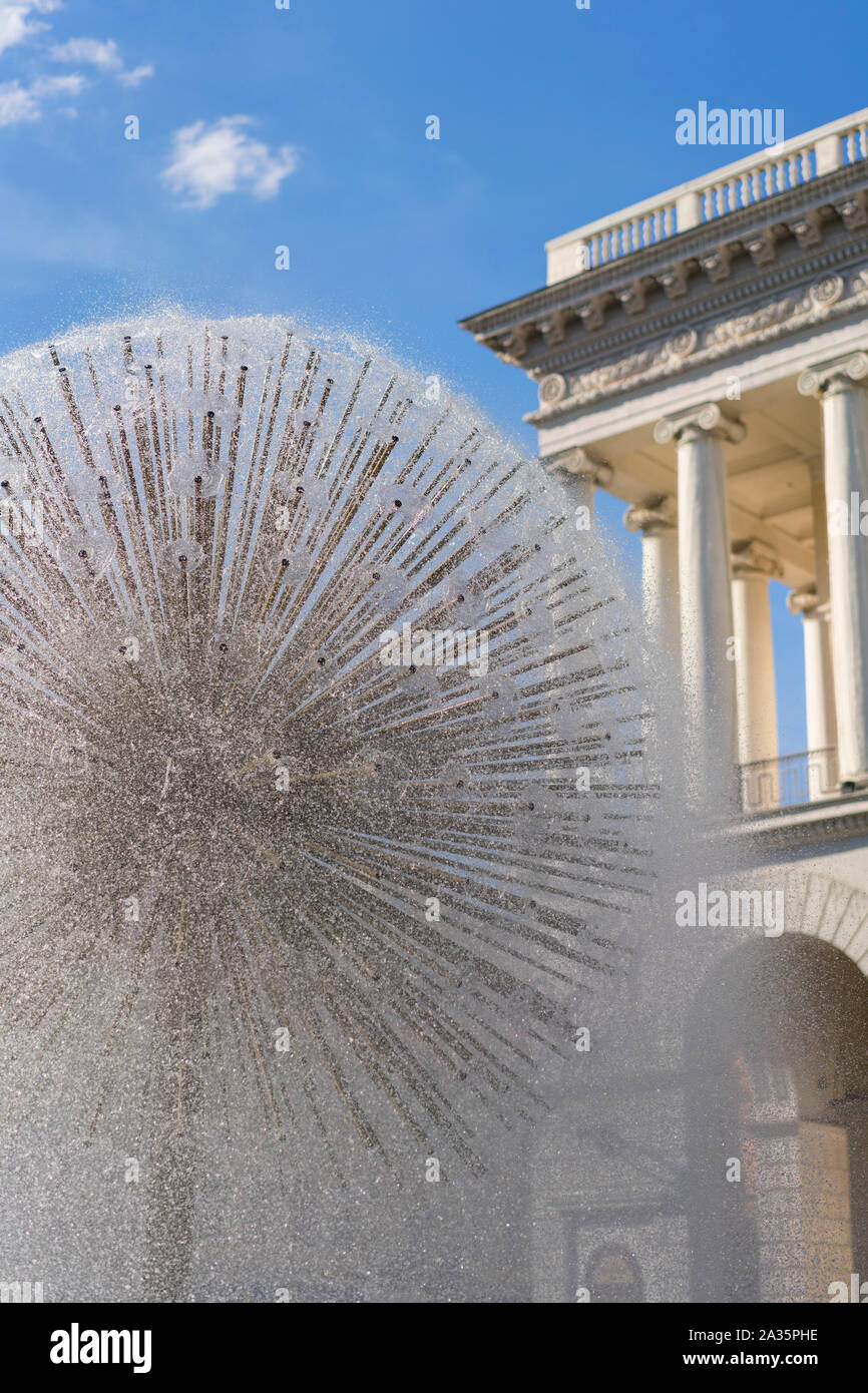 Round fountain against the blue sky. A modern ball-shaped fountain ...