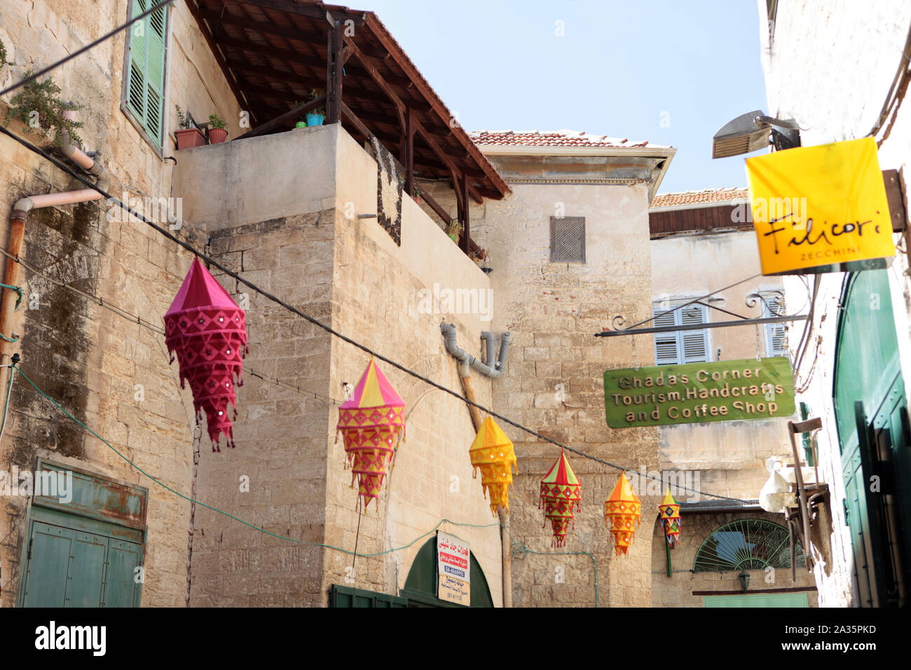 Nazareth, ISRAEL - 10 May 2019: Narrow street with colorful lanterns ...