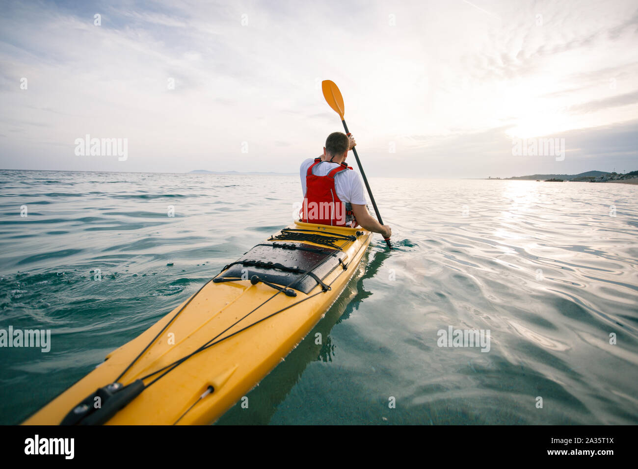 Rear view of man paddling kayak Stock Photo - Alamy