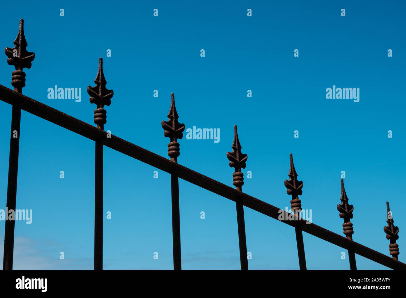 wrought iron spikes on fence isolated on sky - railheads Stock Photo ...