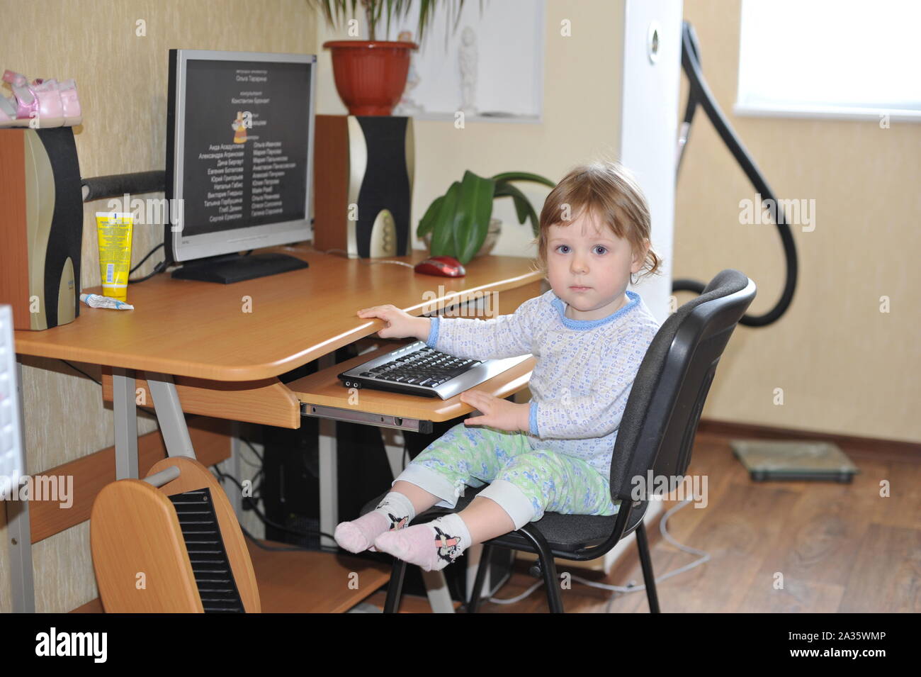 cute little baby girl typing on keyboard sitting at computer Stock ...