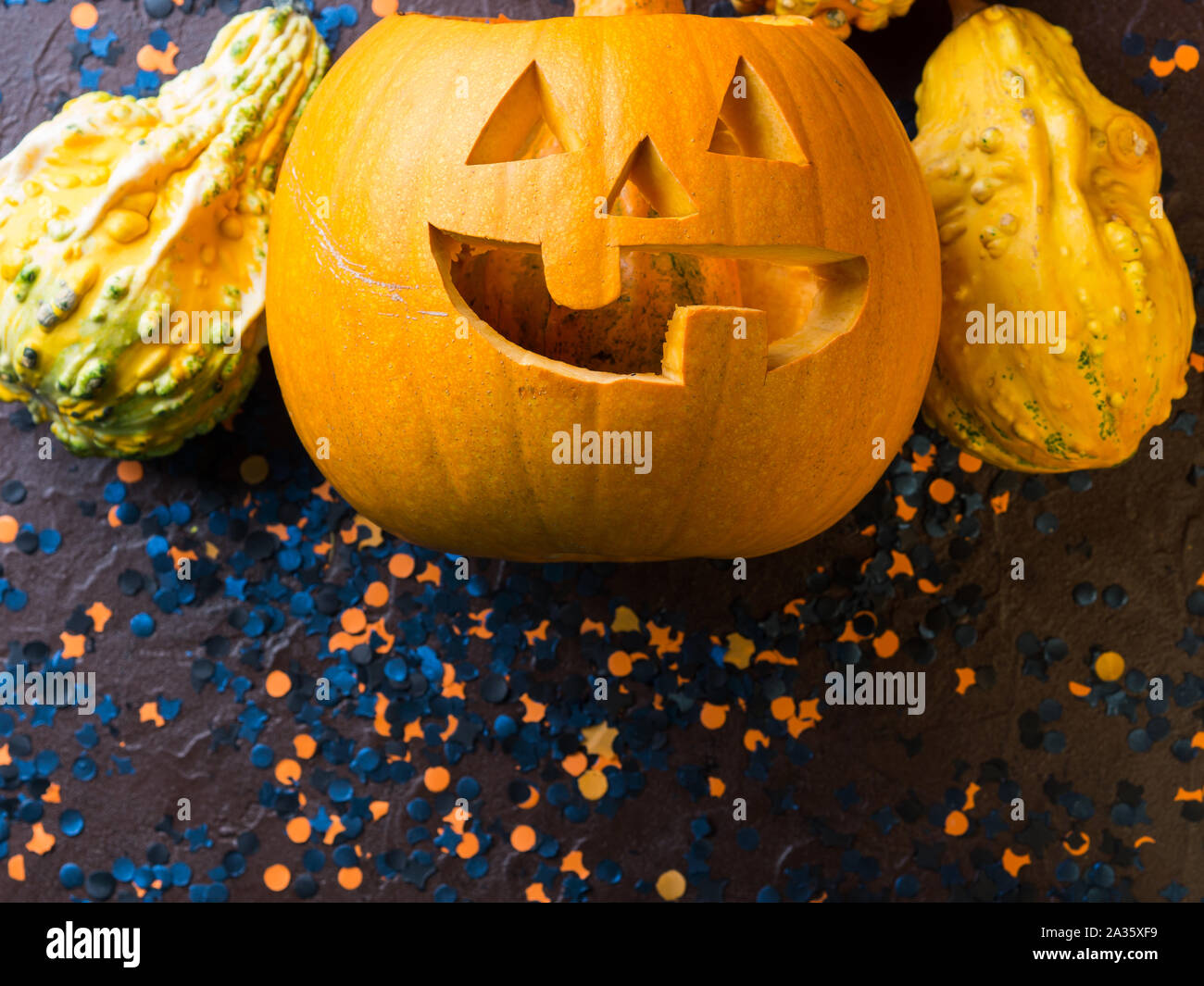 Halloween carved squash and confetti. Dark Holiday spooky background ...