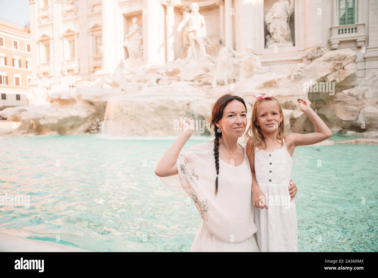 Travel family mom and girl trowing coin at Trevi Fountain, Rome, Italy ...