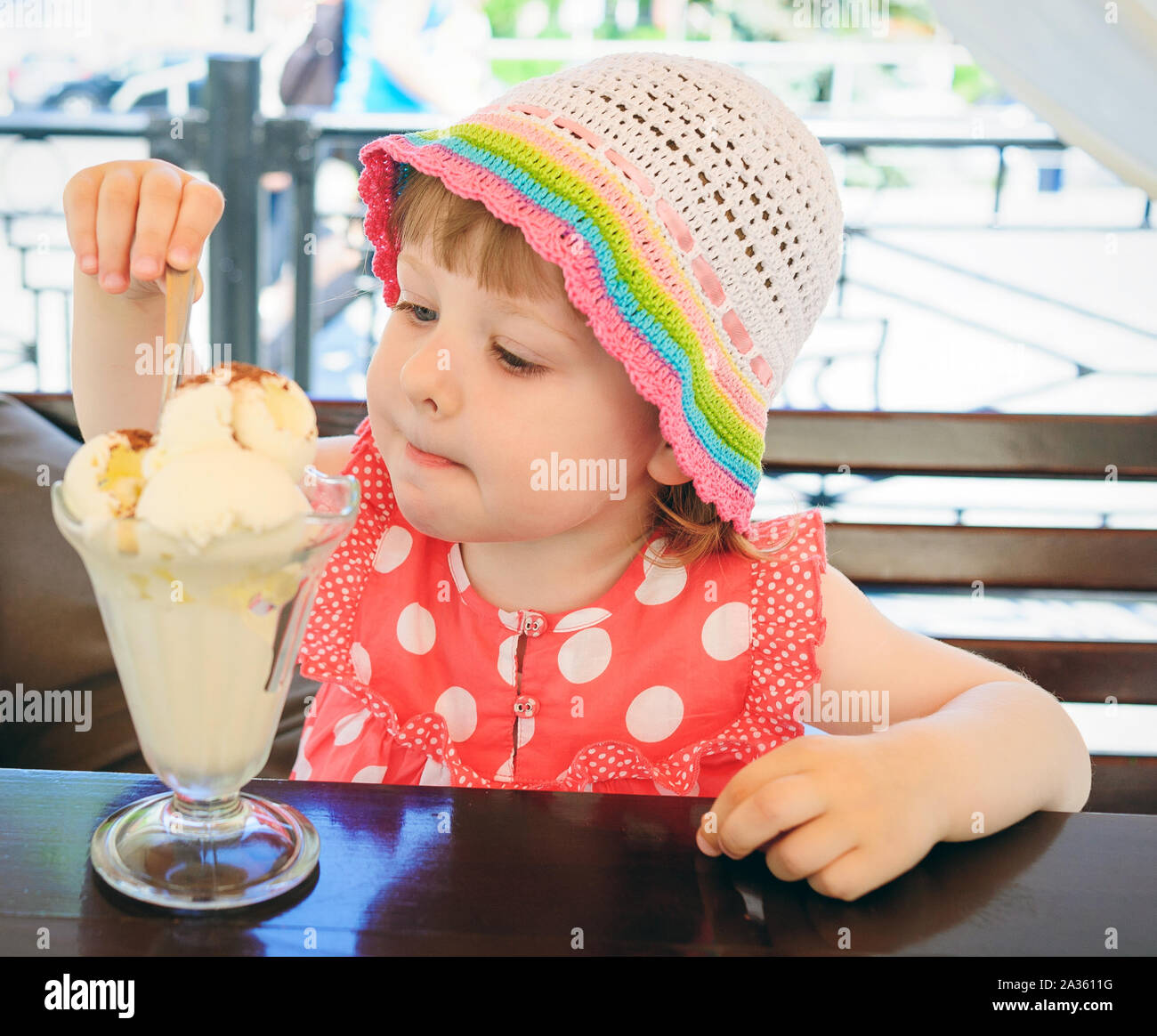 Portrait of a cute girl with ice cream on a walk in the park. child ...