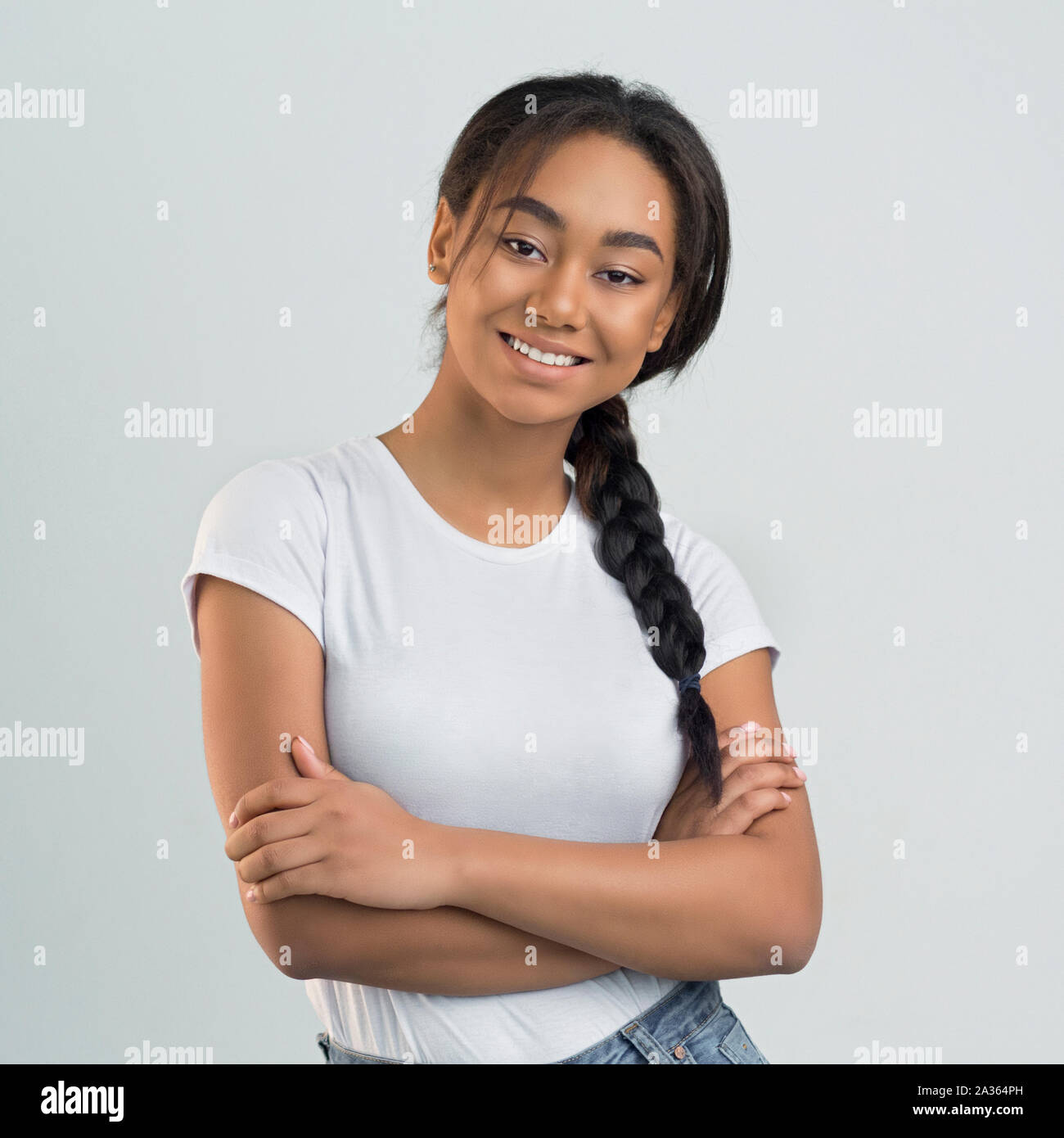 Asian student girl with arms crossed over grey wall Stock Photo - Alamy
