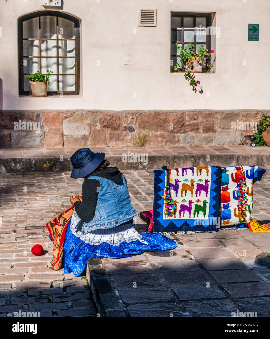 Sacred Valley, Peru - 05/21/2019: Woman hand weaving a colorful textile ...