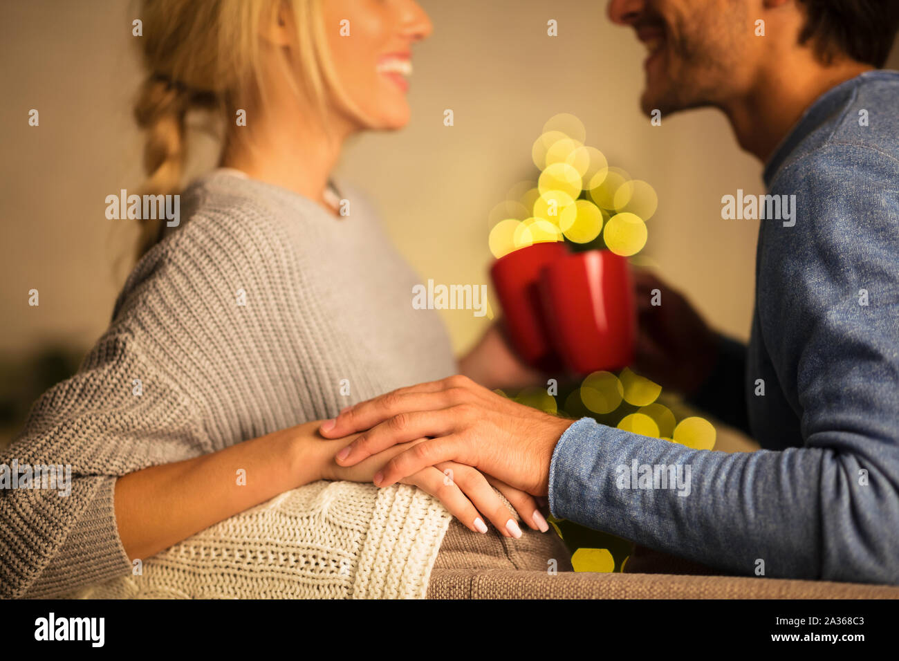 Romantic evening. Couple drinking coffee against Christmas tree Stock ...