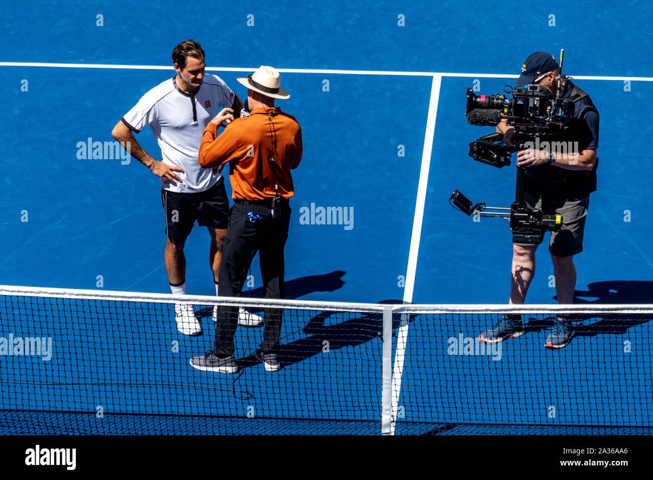 Roger Federer of Switzerland being interviewed by ESPN's Brad Gilbert ...