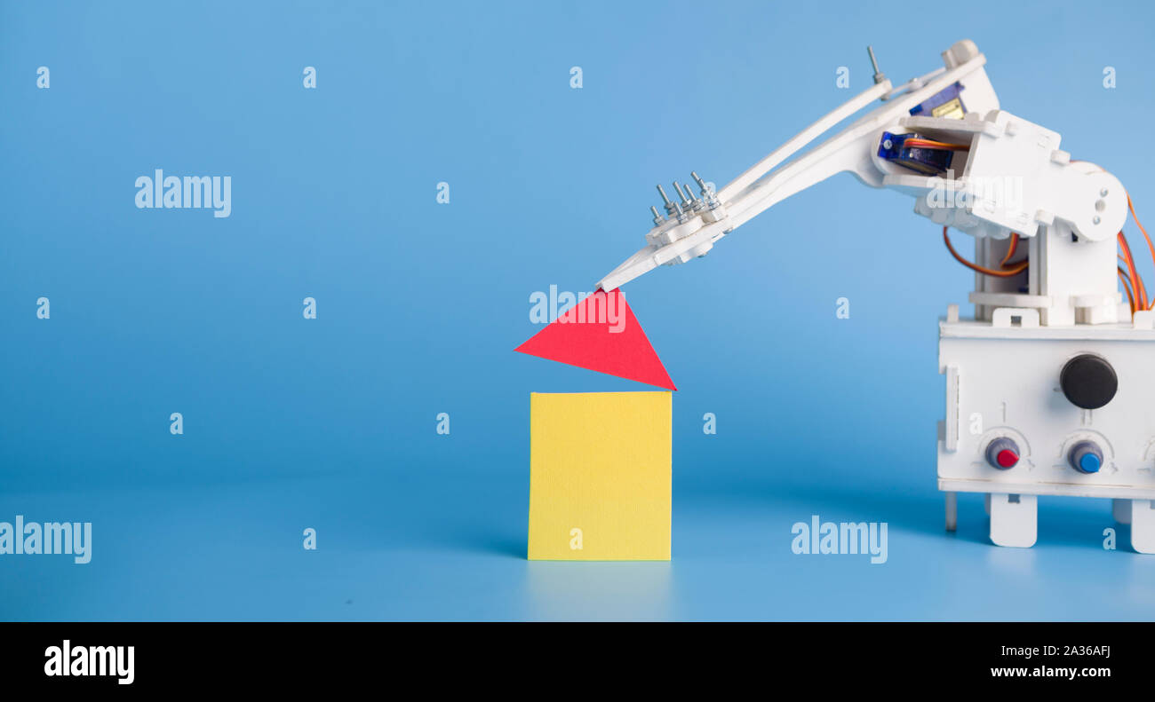 Automated mechanism building house with wooden blocks Stock Photo - Alamy