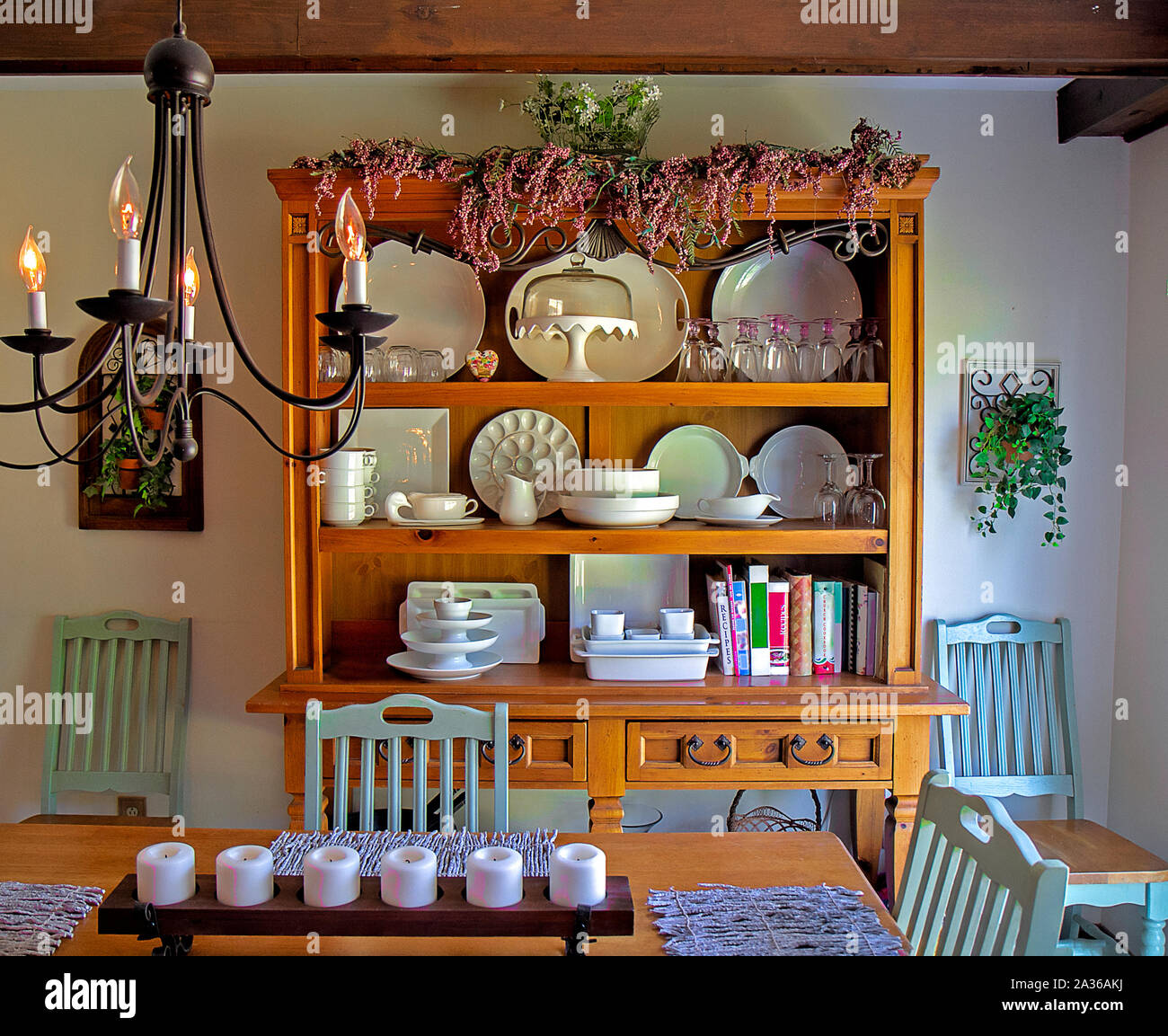 Country large oak open hutch filled with white dishes and table with ...