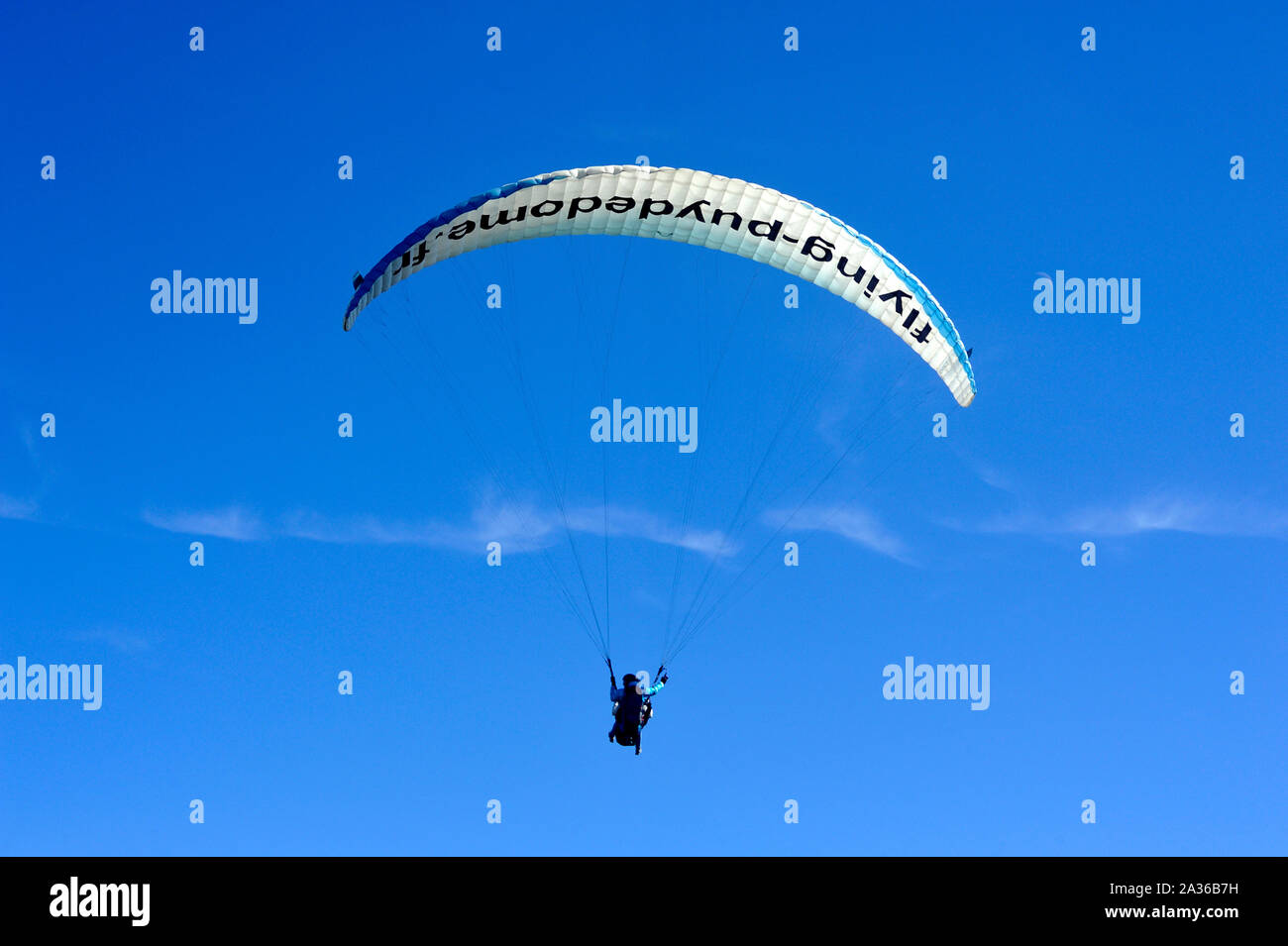 Paragliders in full flight over volcanoes of Puy de Dome in the central ...