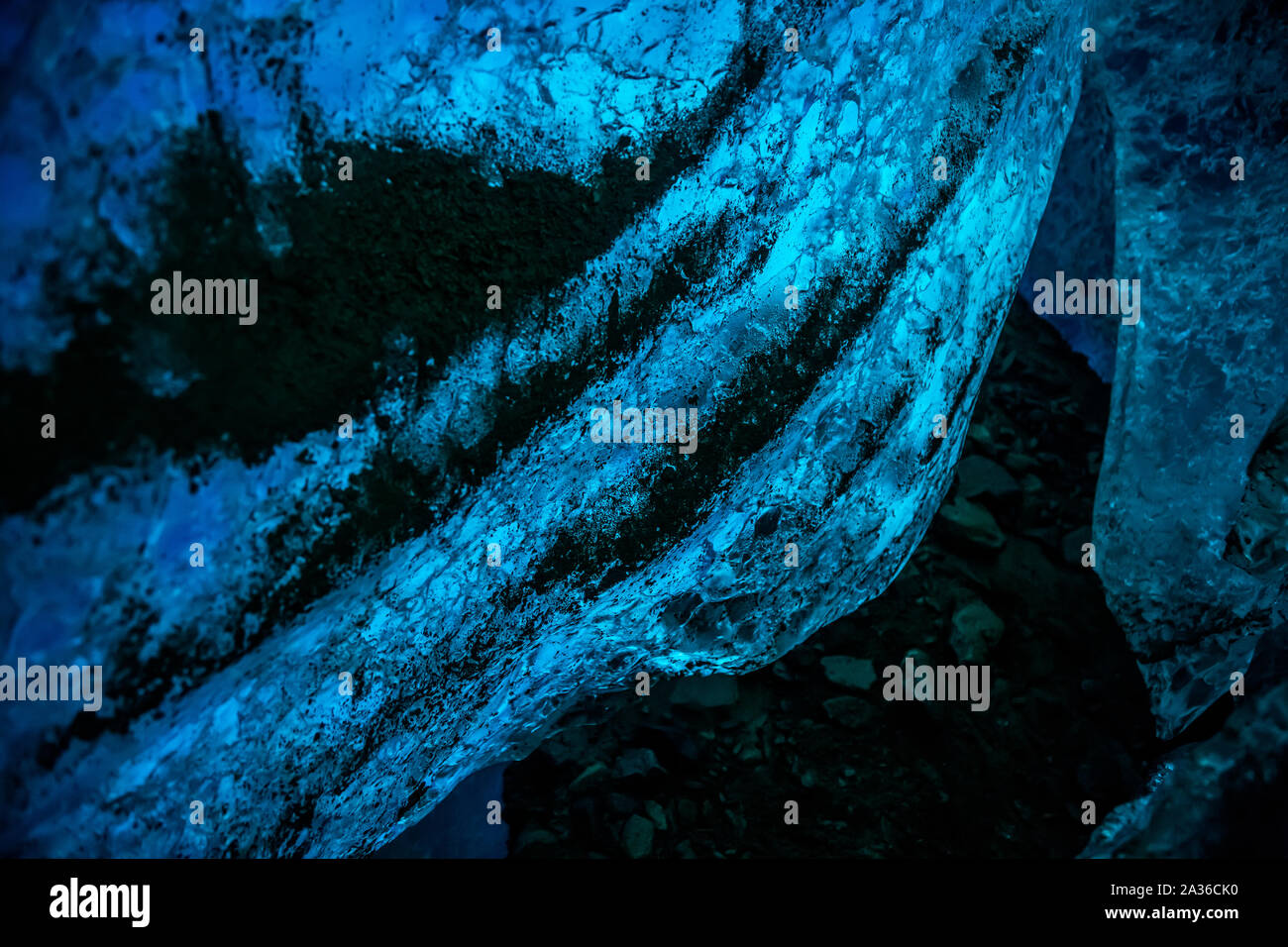 Cracked ice texture in the walls glowing from light above this deep ice ...