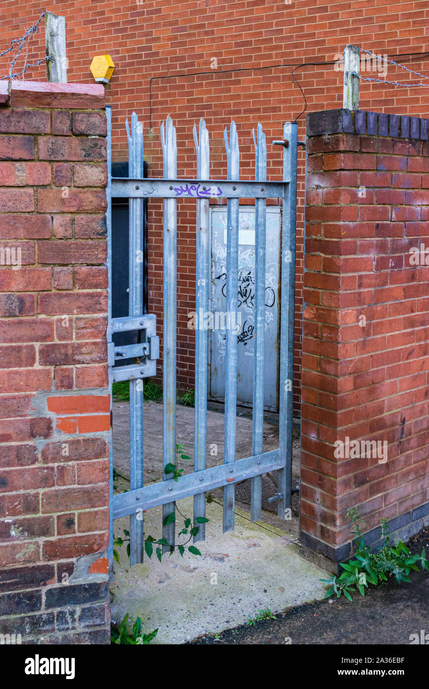 A padlocked security gate at the rear of a commercial premises Stock ...