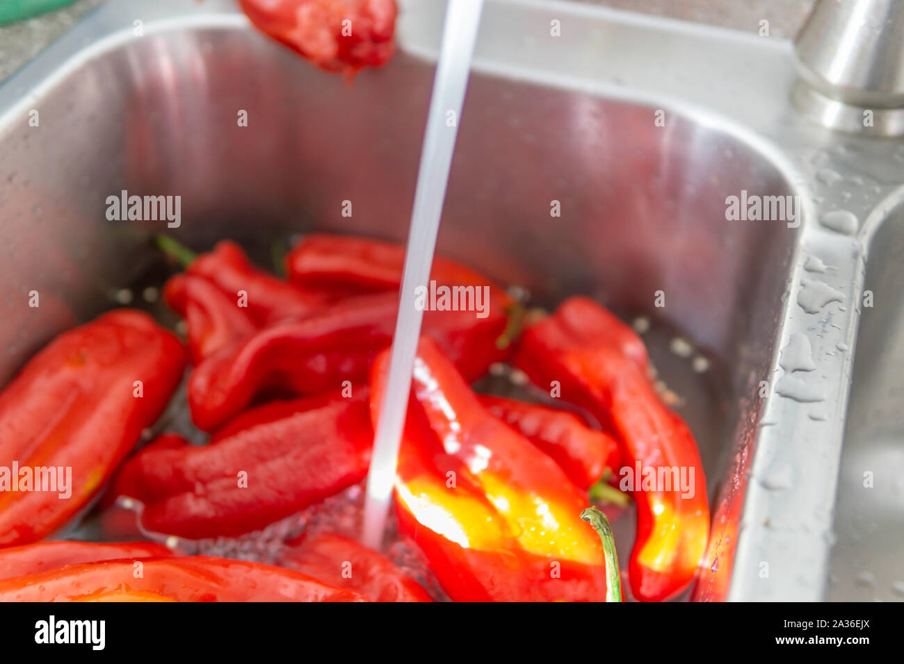 Red bell Peppers washed in a Kitchen Sink Stock Photo - Alamy