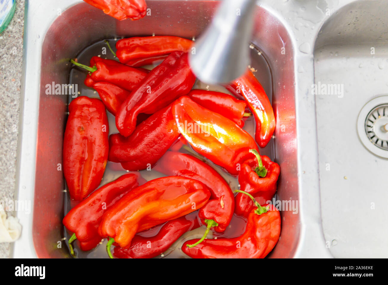Red bell Peppers washed in a Kitchen Sink Stock Photo - Alamy