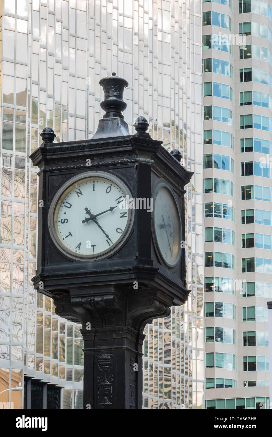 Old clock located at historic Union Station with modern skyscrapers in ...