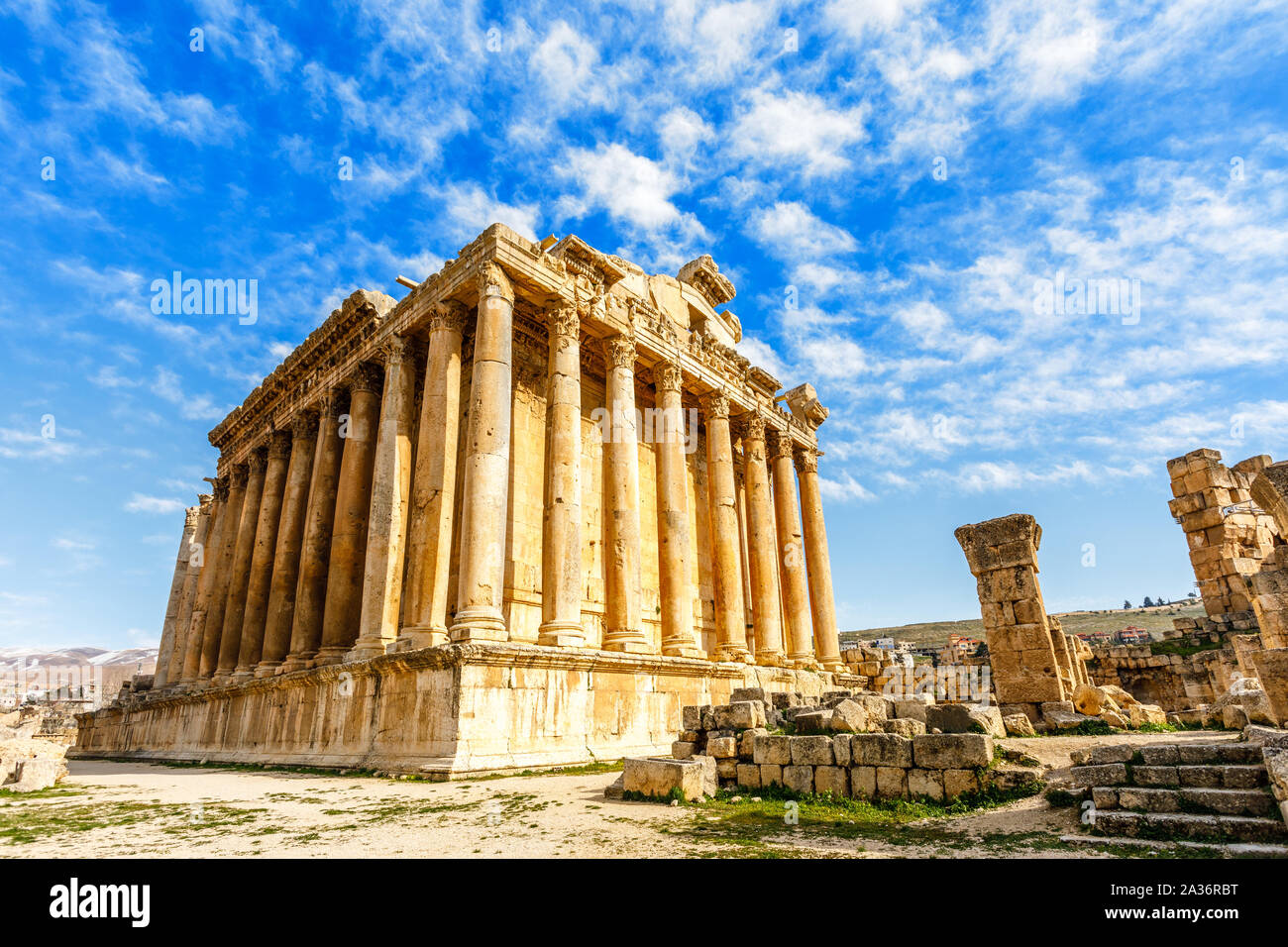Ancient Roman temple of Bacchus with surrounding ruins with blue sky in ...
