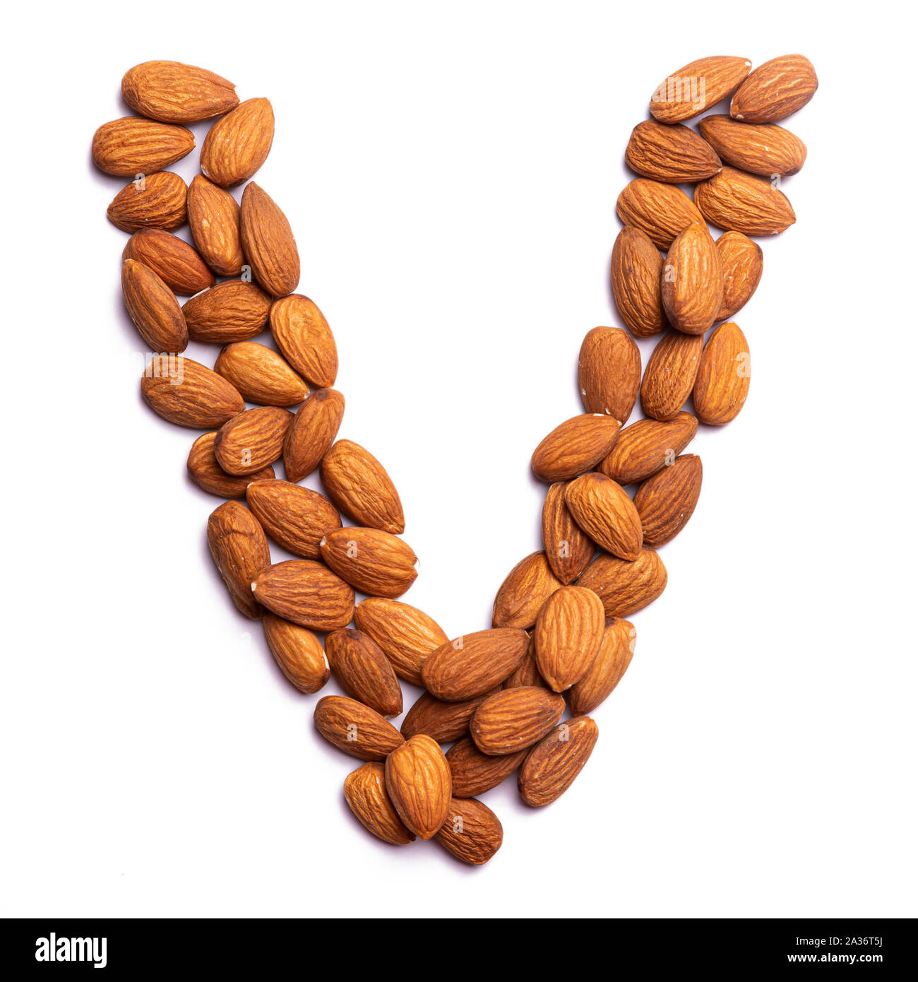 The letter "V" of the English alphabet from a peeled almond on a white ...