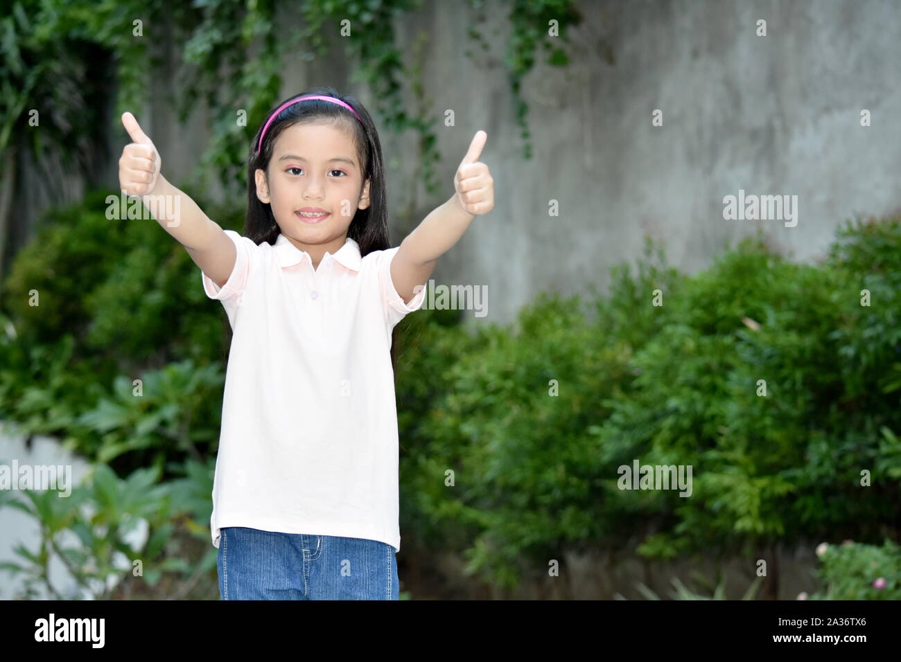 A Cute Girl With Thumbs Up Stock Photo - Alamy