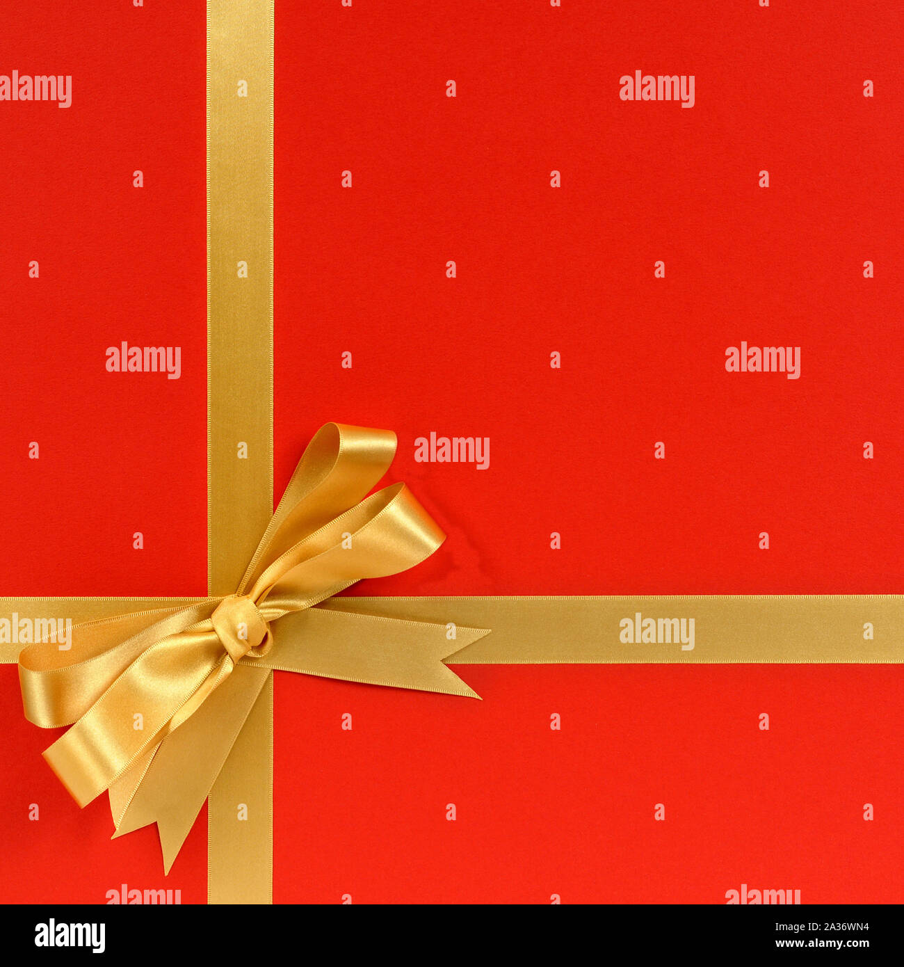 Christmas gift border frame with gold ribbon and bow and red background ...