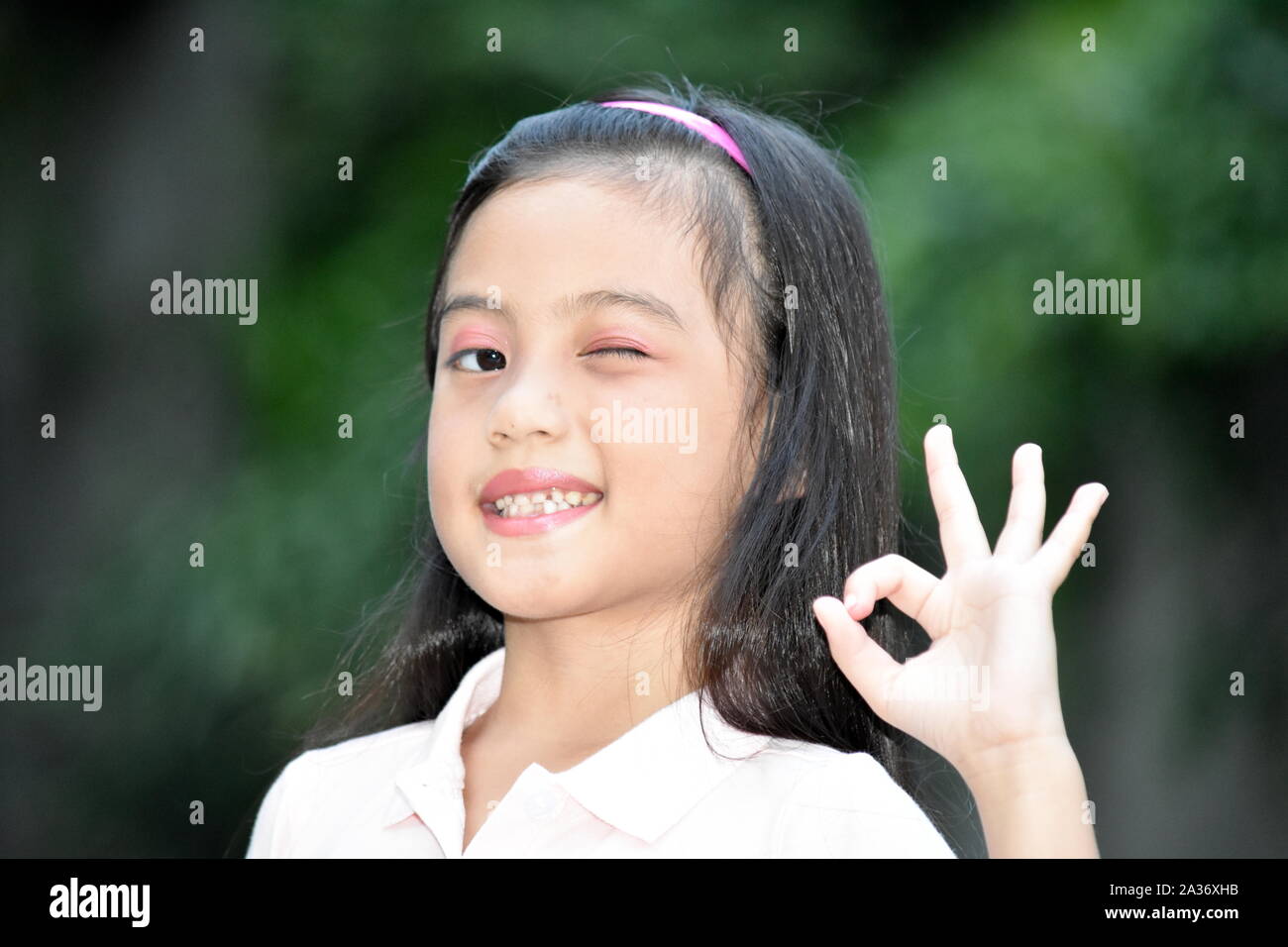 A Girl And Okay Sign Stock Photo - Alamy