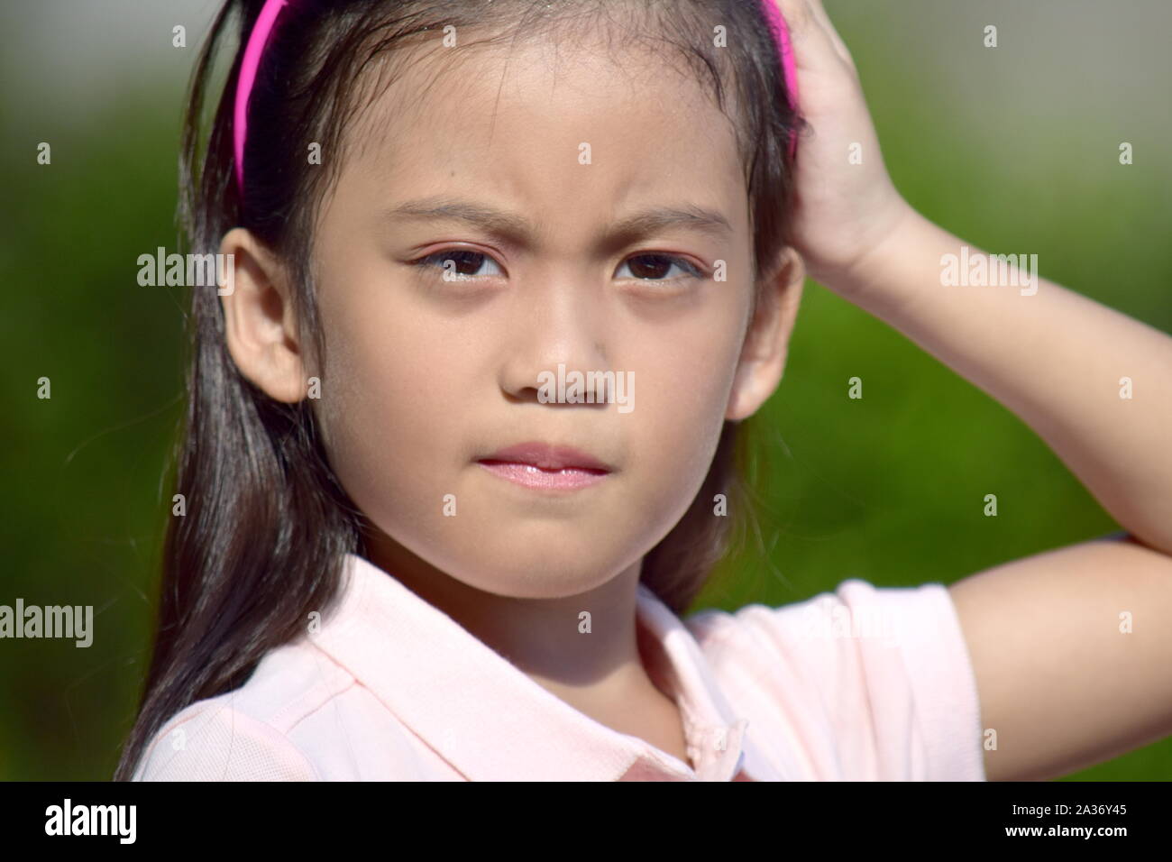 A Confused Petite Girl Child Stock Photo - Alamy