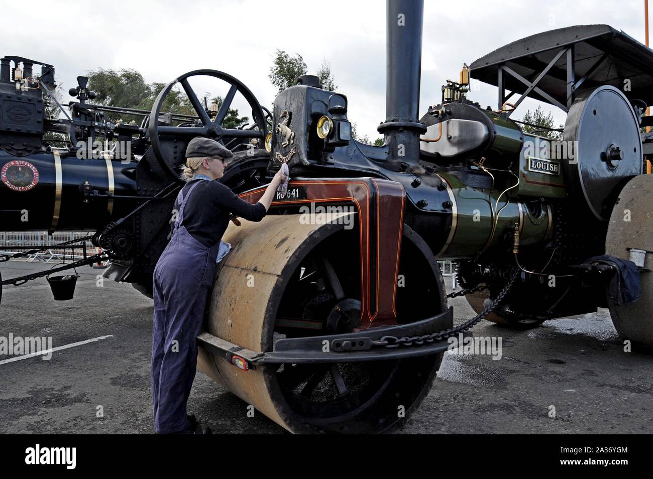A woman cleans her Aveling and Porter steam roller at a display of ...