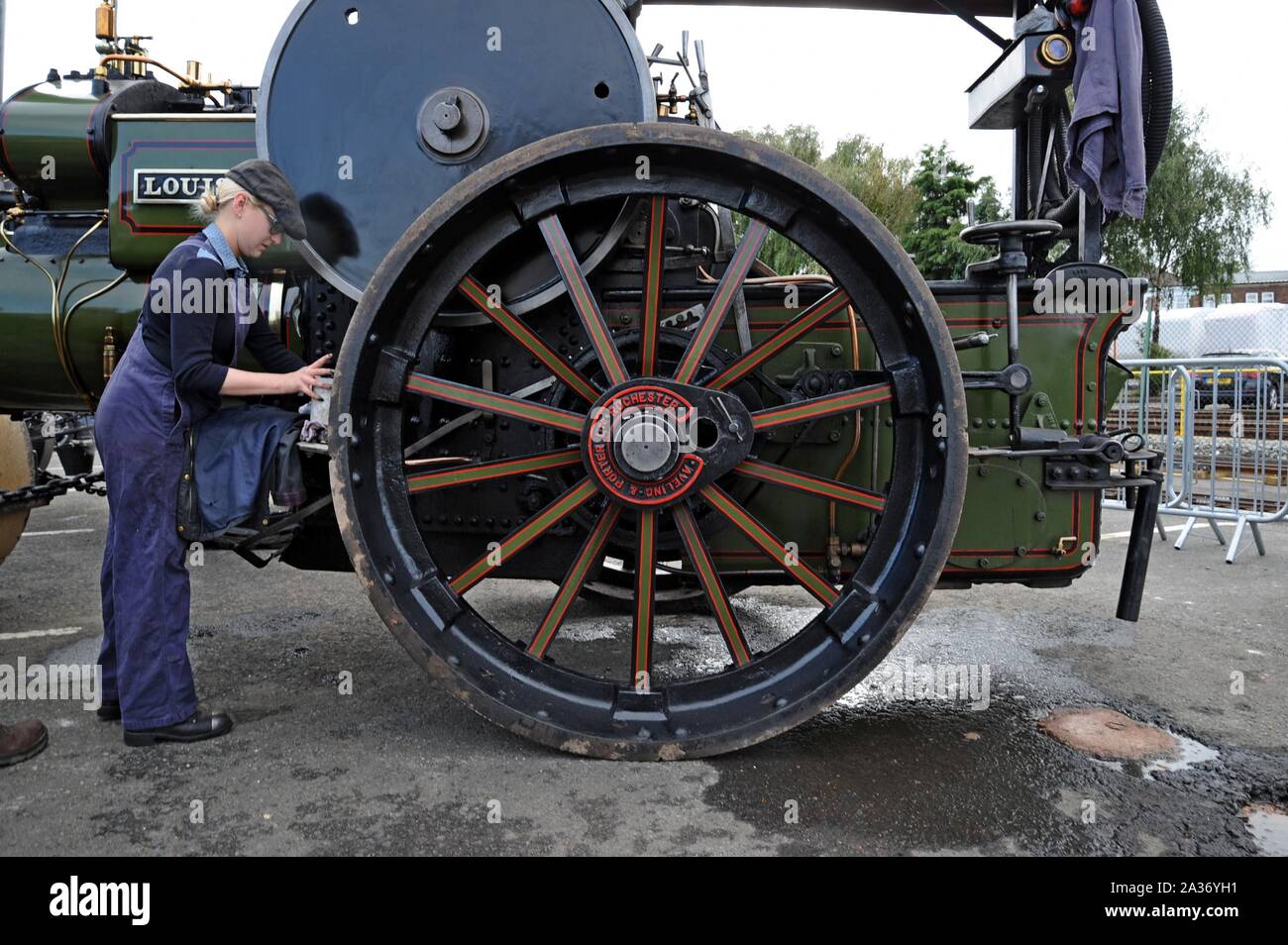 A woman cleans her Aveling and Porter steam roller at a display of ...