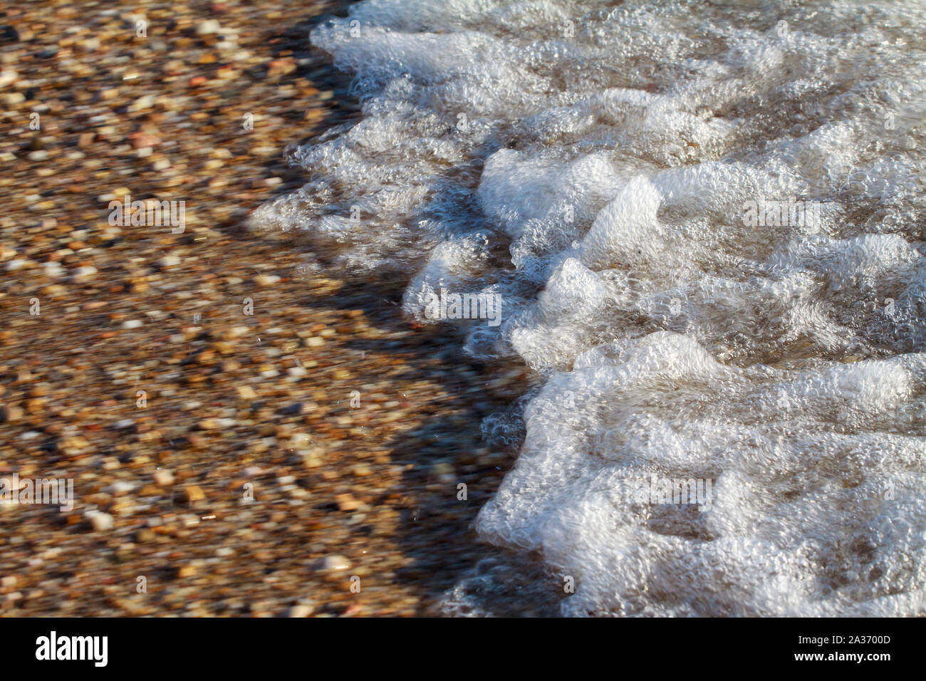 sea pebbles colored granite on the beach background stones. The shore ...