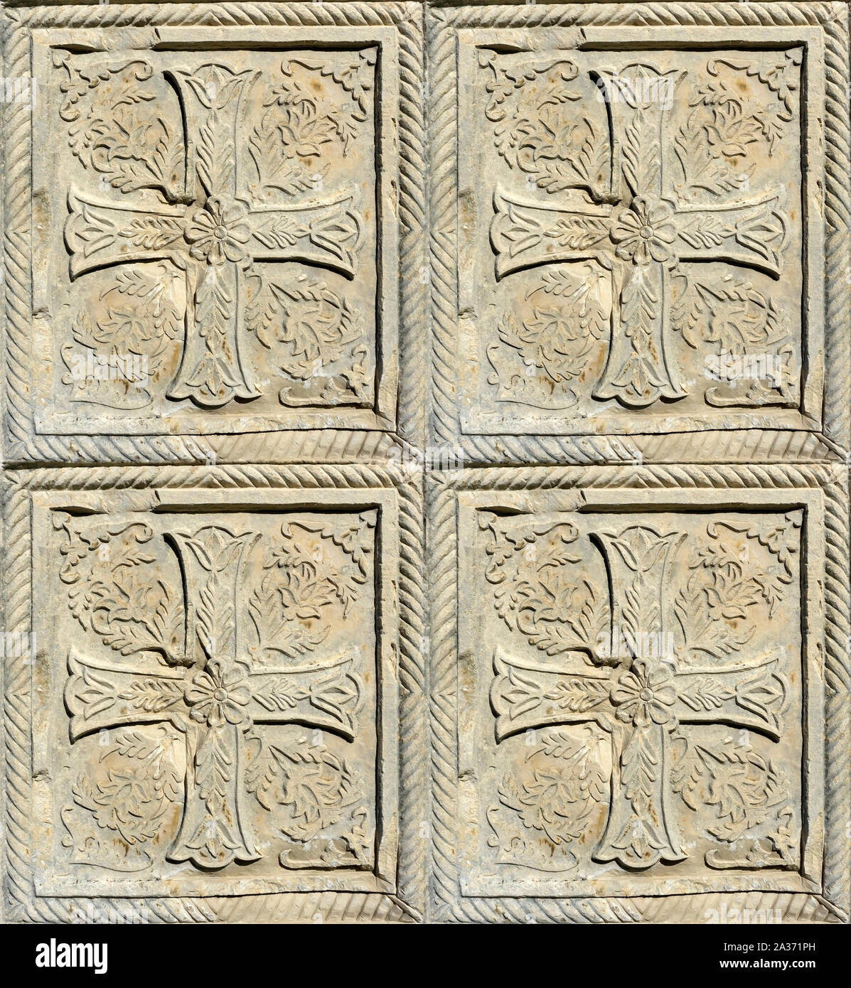 Christian pattern carved in stone on the wall of an old Christian ...