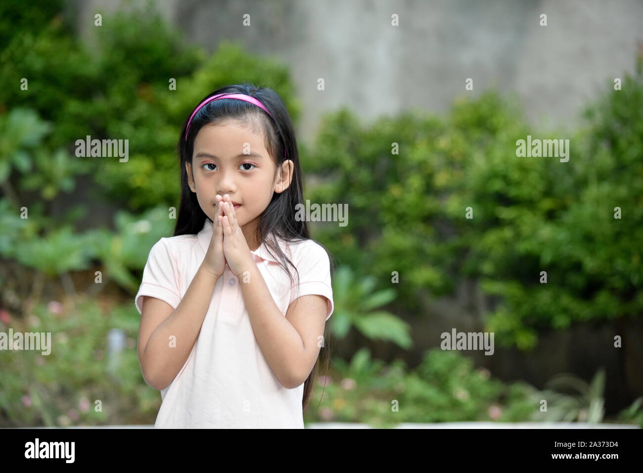 A Praying Cute Diverse Girl Stock Photo - Alamy