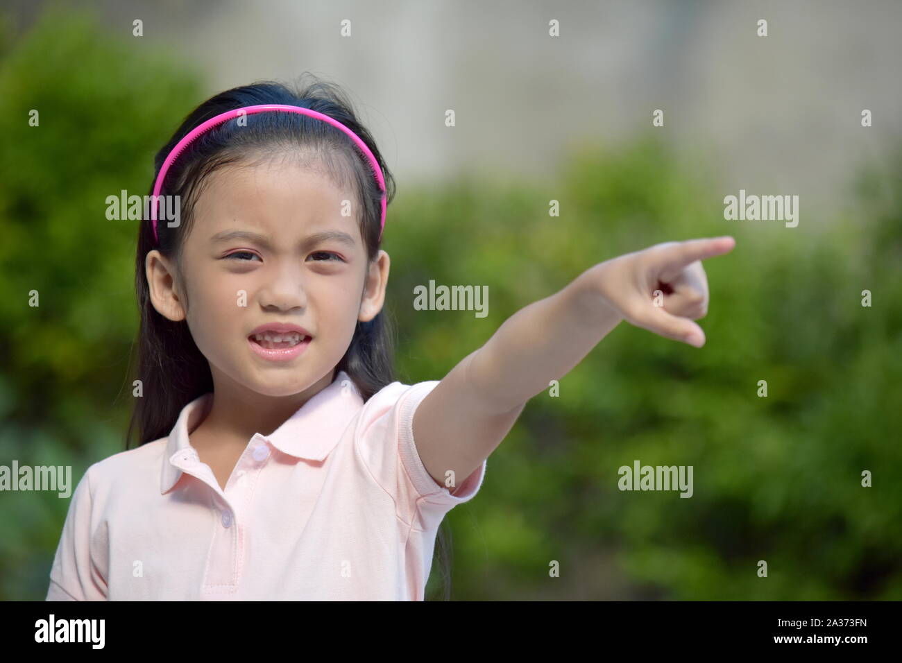 An A Diverse Girl Pointing Stock Photo - Alamy