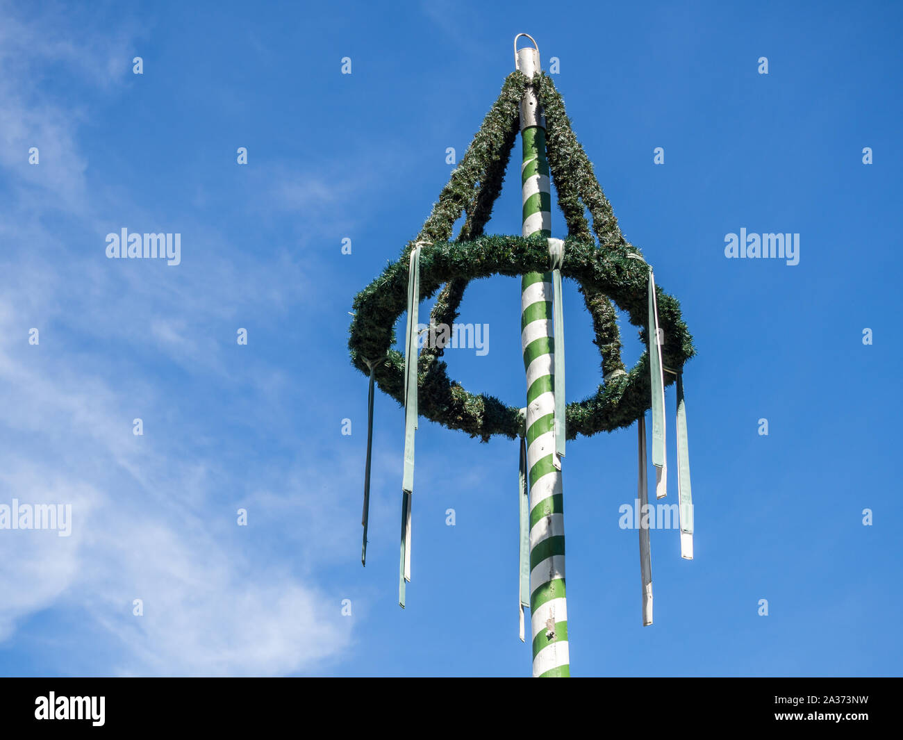 Maypole with blue background Stock Photo - Alamy