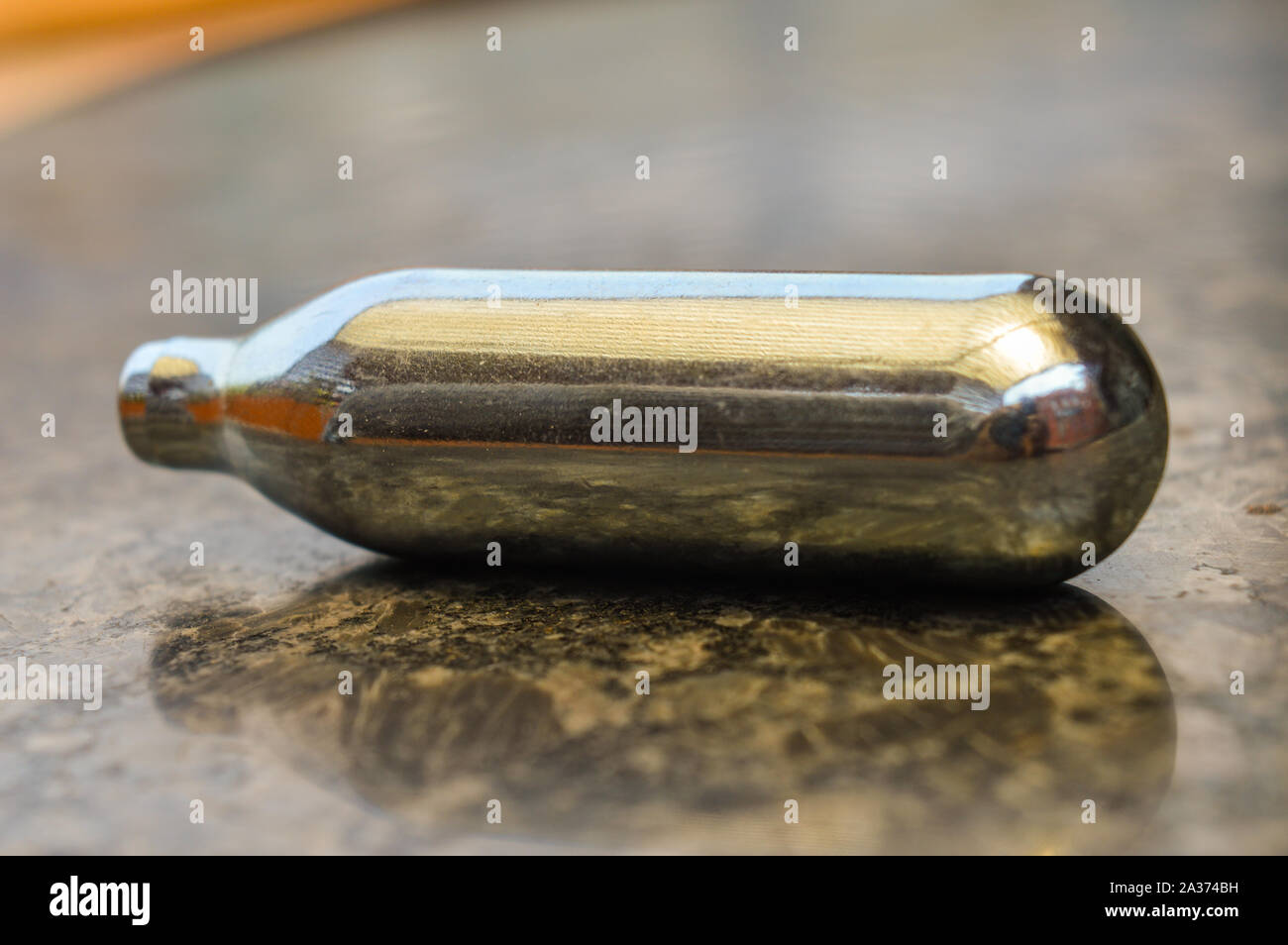 A small gas cylinder isolated on table Stock Photo - Alamy