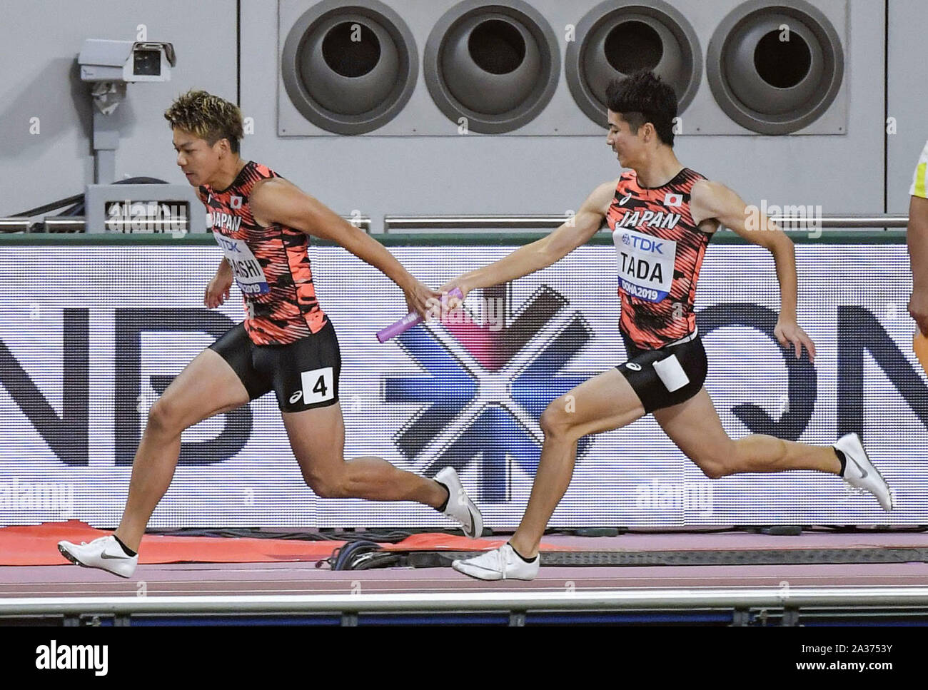 Japan's Shuhei Tada (R) hands the baton to Kirara Shiraishi in the men ...