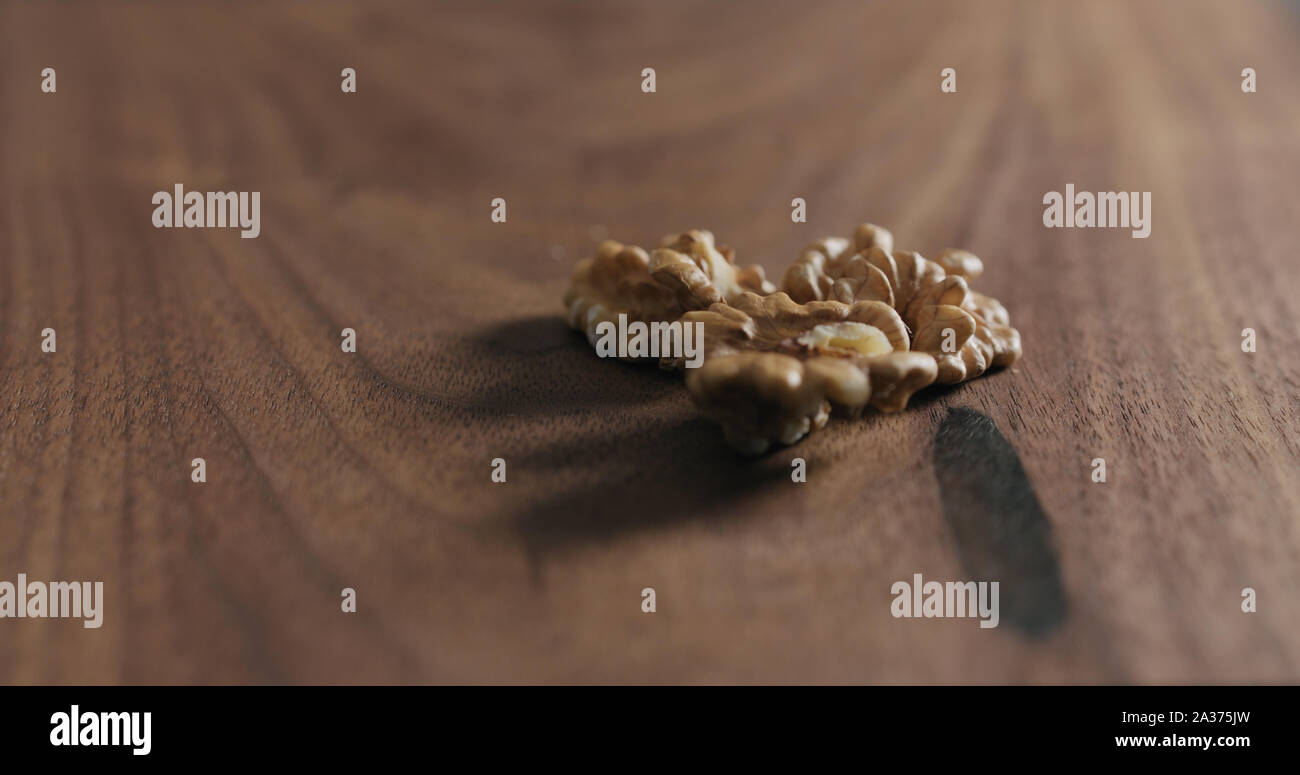 peeled walnut on walnut wood surface, wide photo Stock Photo - Alamy