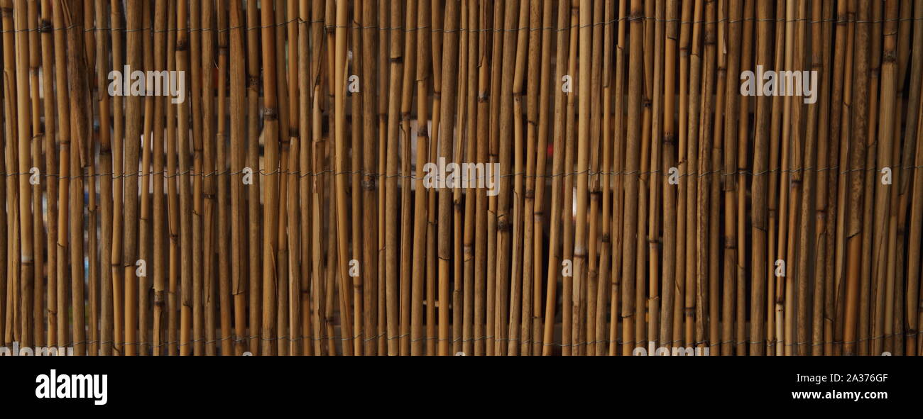 a dark reed mat as a background Stock Photo - Alamy