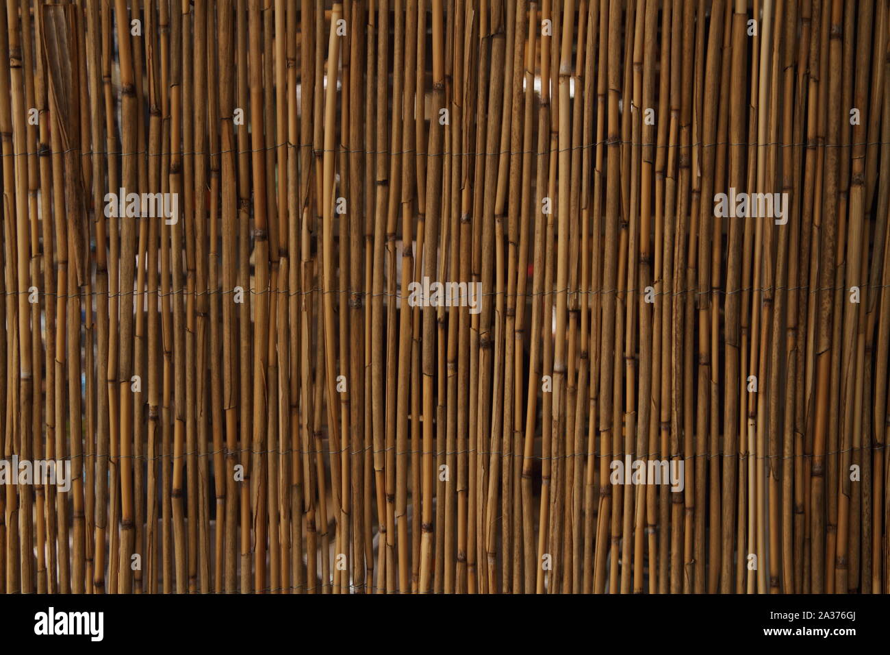 a dark reed mat as a background Stock Photo - Alamy