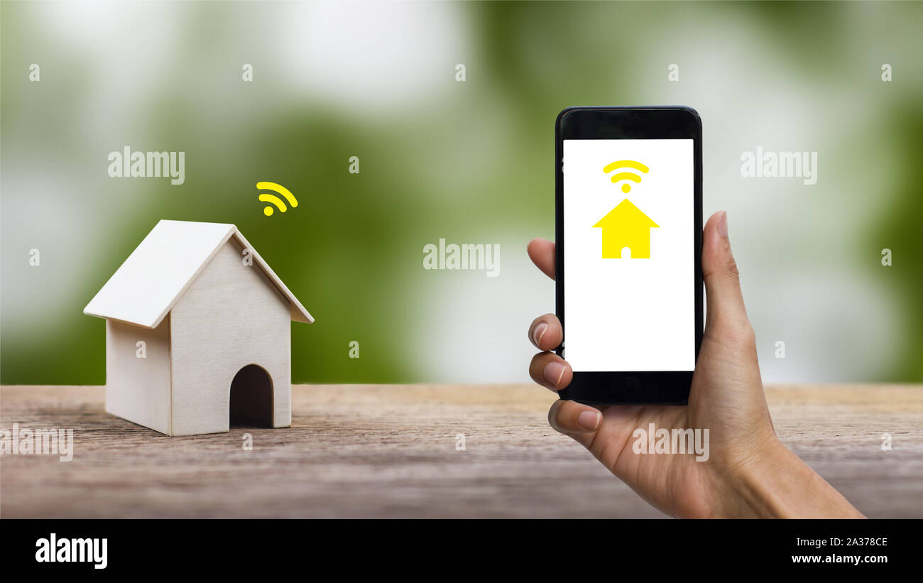 Smart home future technology concept. A man hand using smartphone ...