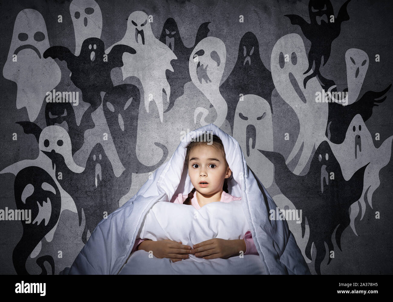 Excited girl hiding under blanket from imaginary ghosts. Scared kid ...