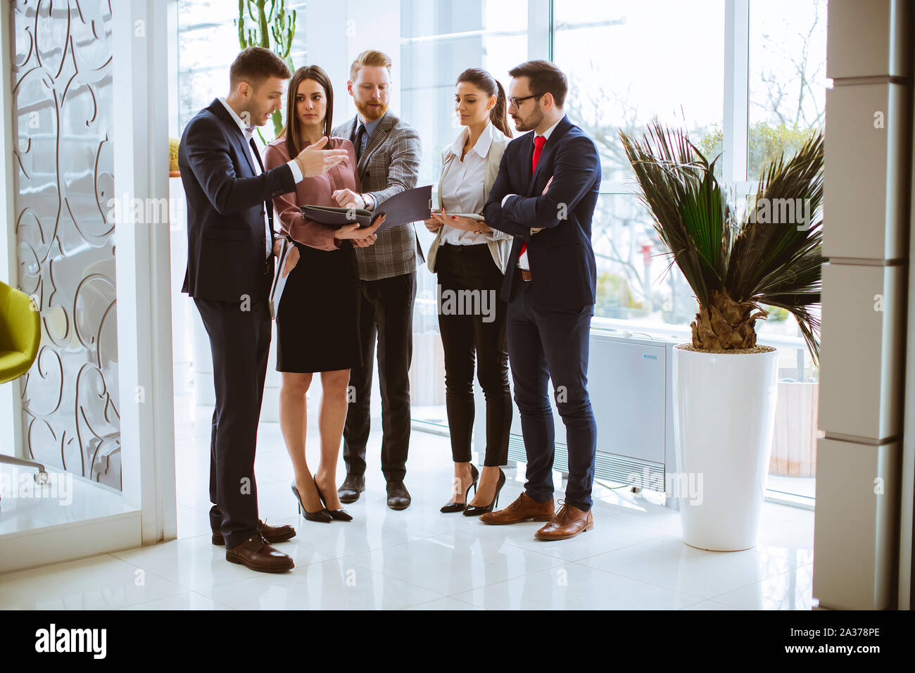 Group of successful business people standing in the office Stock Photo ...