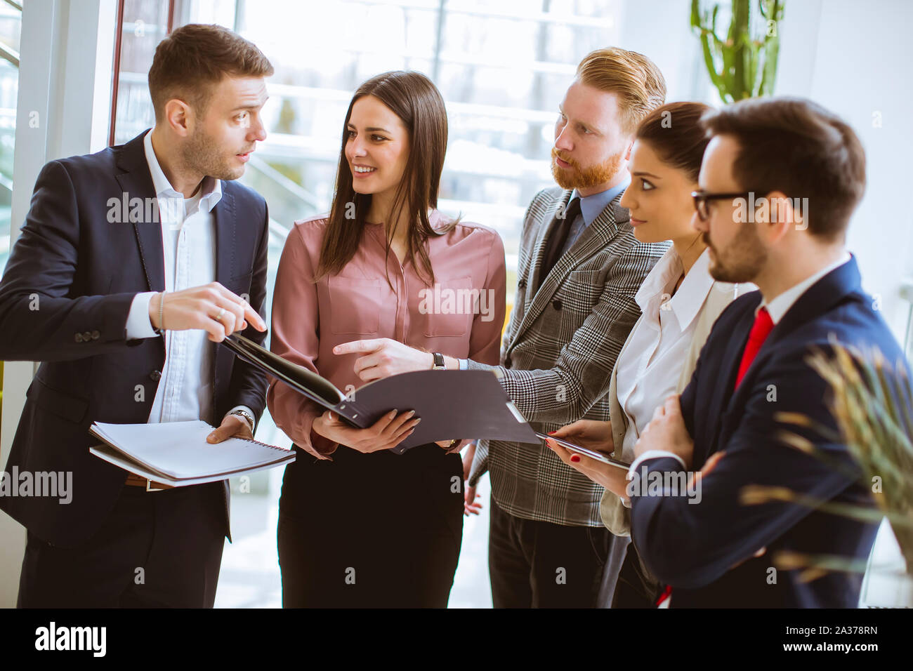 Group of successful business people standing in the office Stock Photo ...