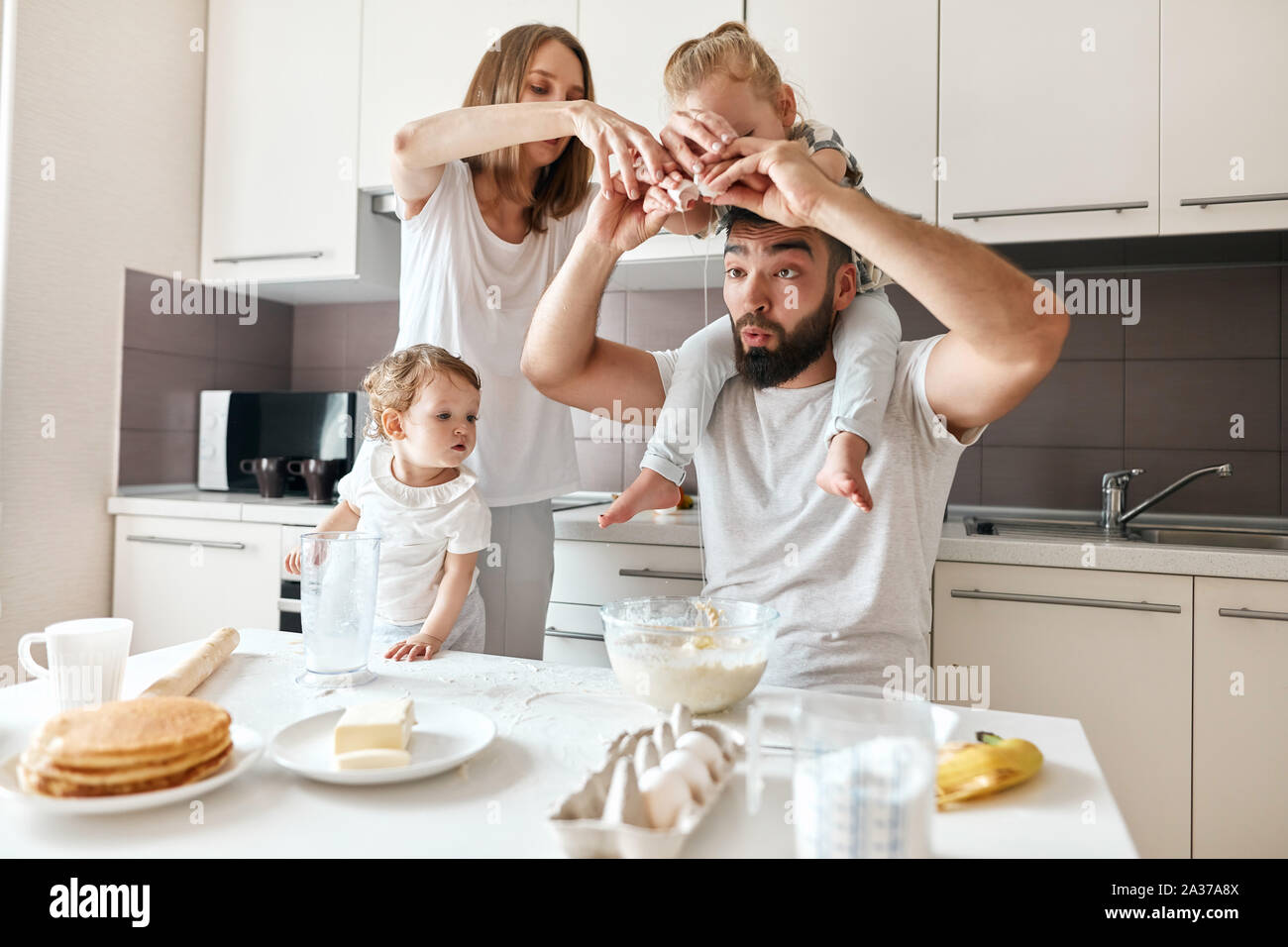 kids giving a helping hand to their parents while preparing breakfast ...