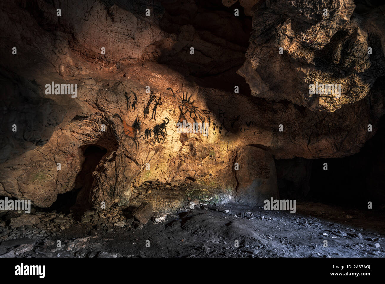 Drawing of an ancient Stone Age man in a cave. Prehistoric painting ...
