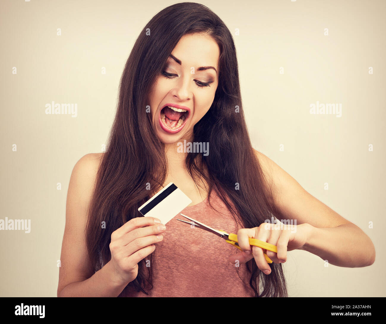 Beautiful crazy crying angry woman with open mouth cutting her credit ...