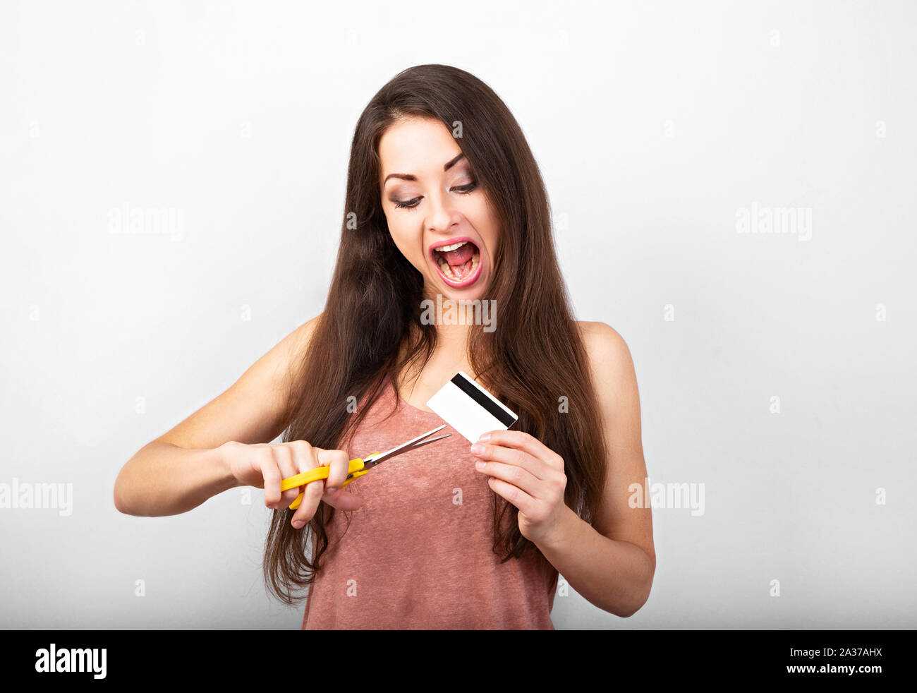 Beautiful crazy crying angry woman with open mouth cutting her credit ...