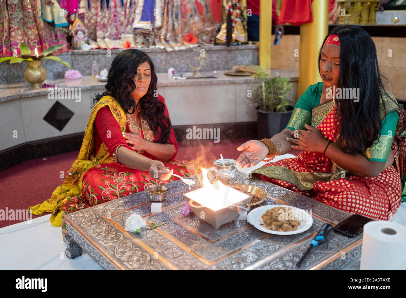 At the beginning of services for Navarati, A Hindu priestess (green ...